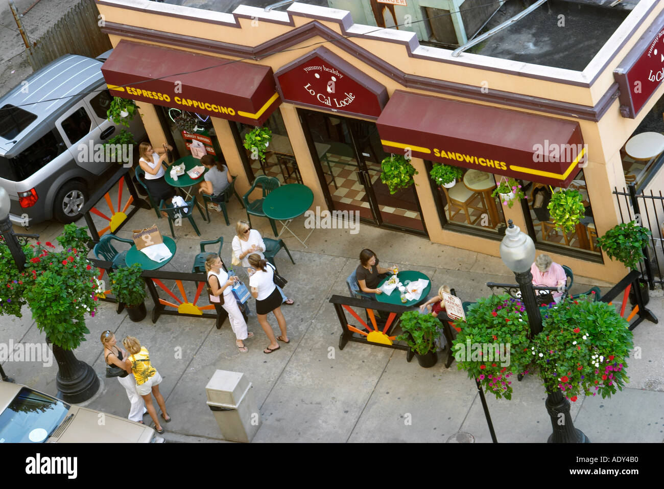 STREET SCENE Chicago Illinois Women sit tables talk standing outside ...