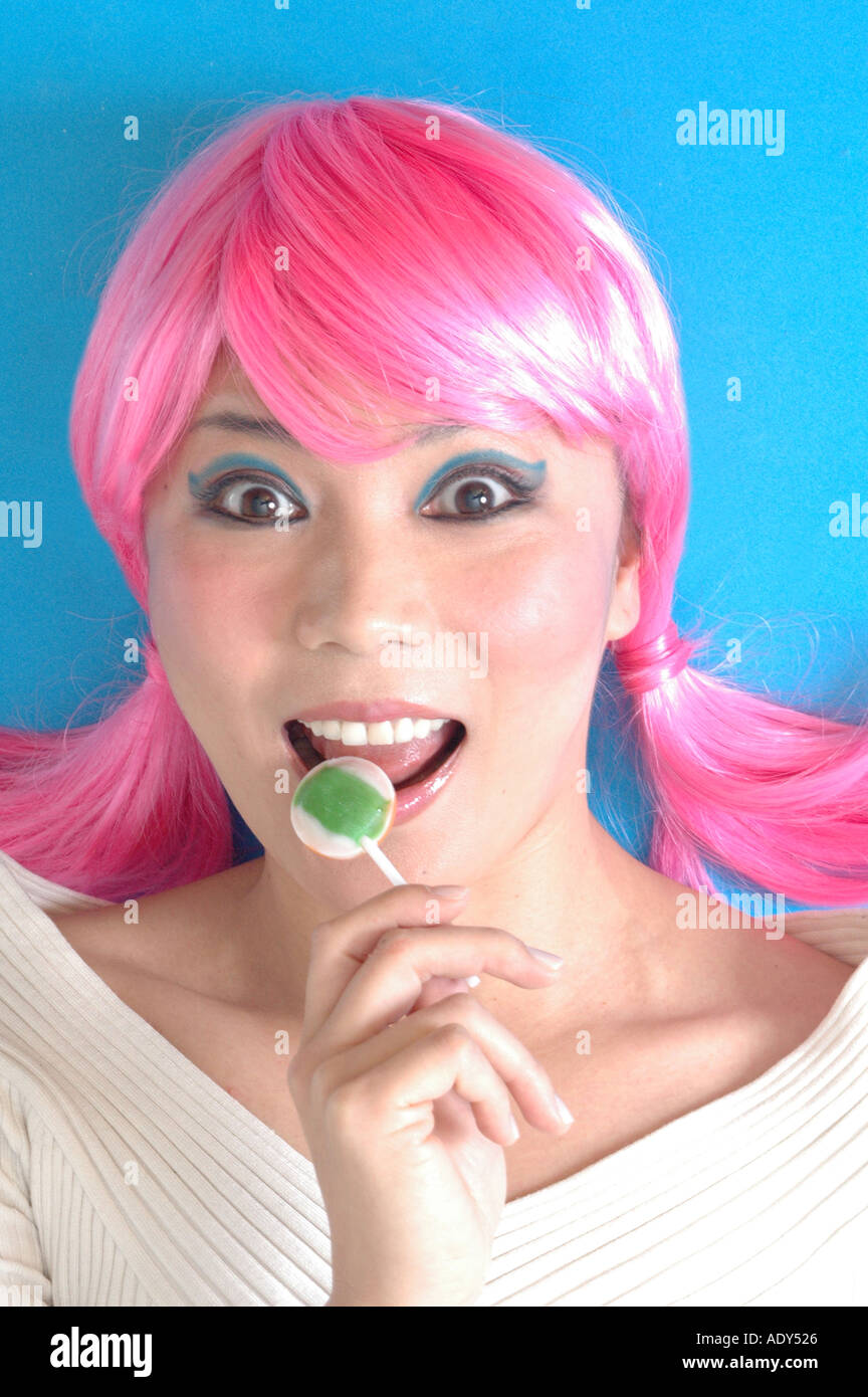 Asian girl eating a lolly Stock Photo - Alamy