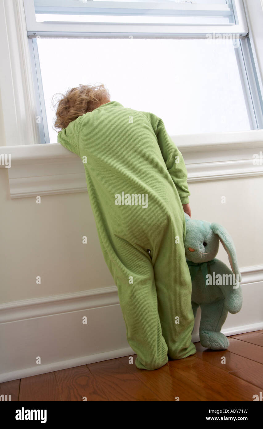 Child Standing by Window Stock Photo - Alamy