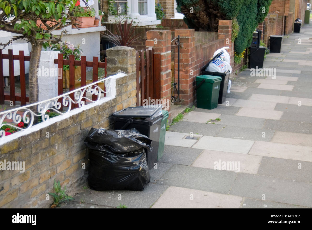 Rubbish bins on the pavement awaiting collection Stock Photo - Alamy