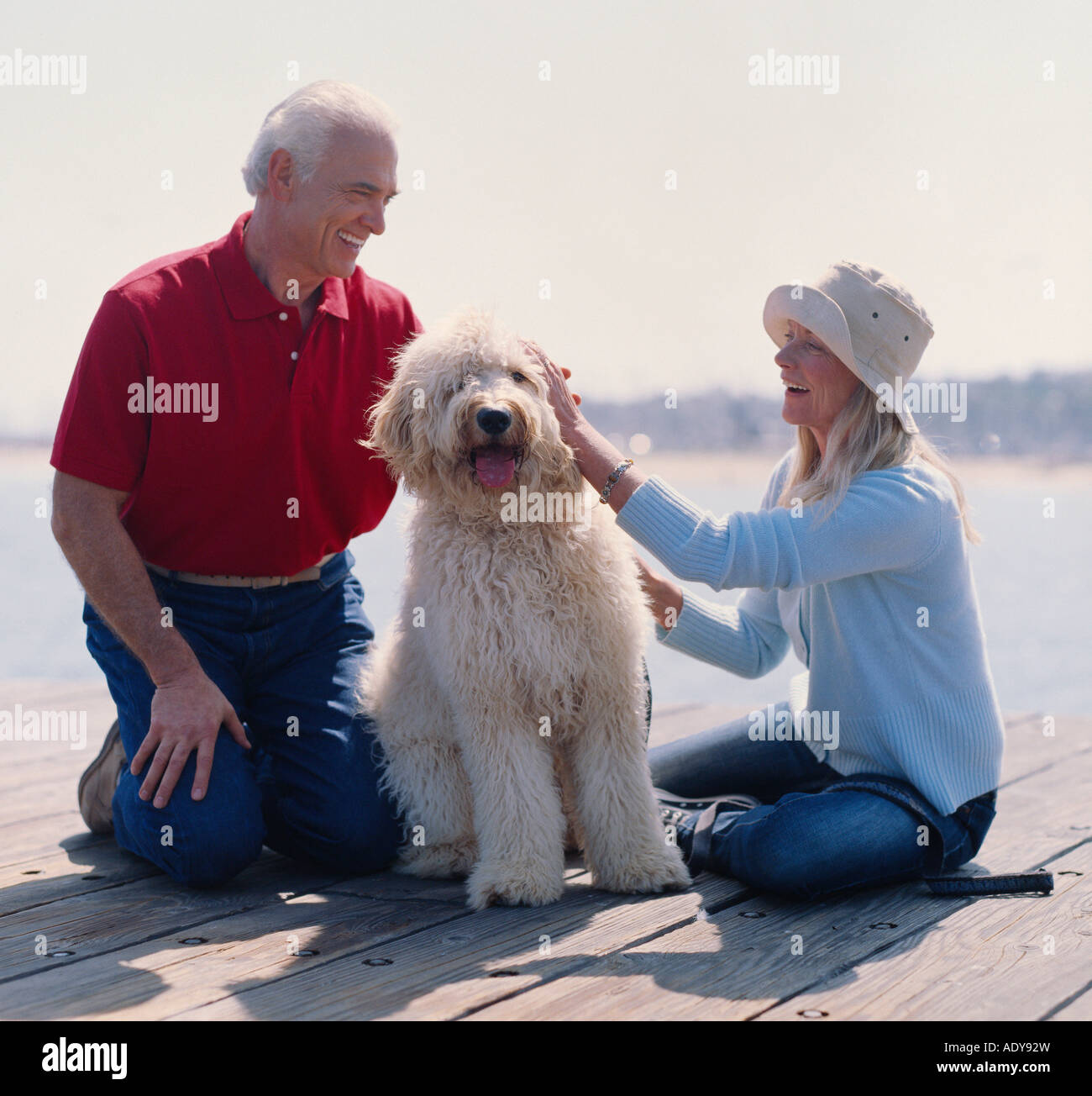 Couple with Dog on Wharf Stock Photo - Alamy