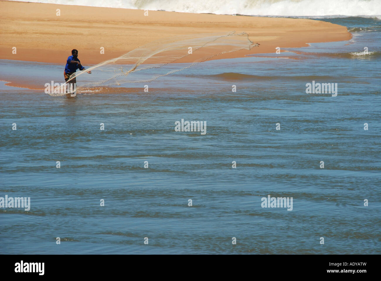 a fisherman throwing his net for fishing Stock Photo - Alamy