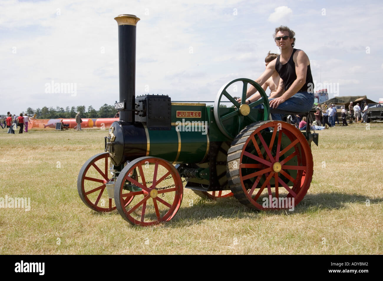 a man driving a scale steam traction engine at Rougham Fair in Suffolk ...