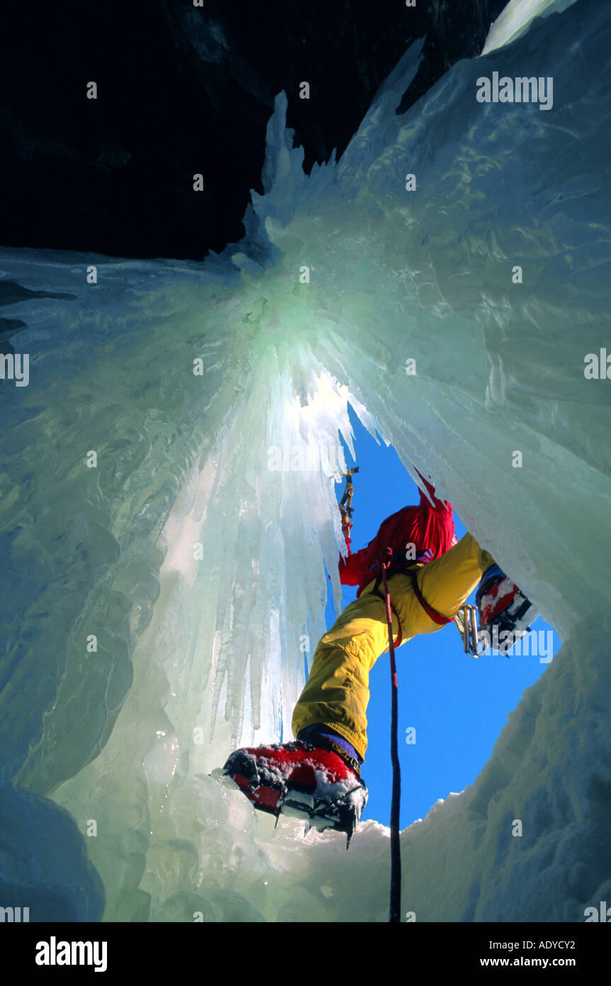 ice climber, view through hole in frozen waterfall Stock Photo - Alamy