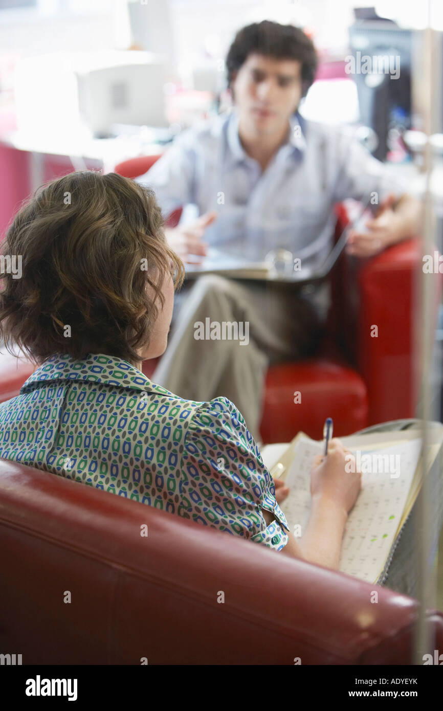 Two office workers sitting on sofas, elevated view Stock Photo - Alamy
