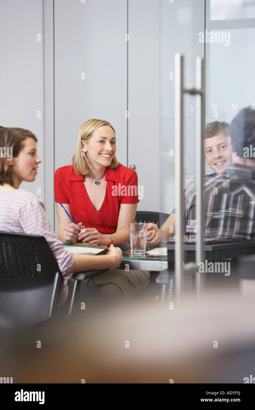 Office workers sitting around conference table Stock Photo - Alamy