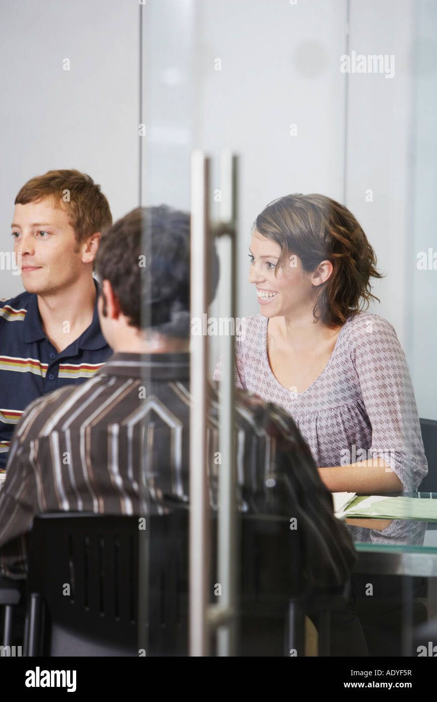 Office workers sitting around conference table Stock Photo - Alamy