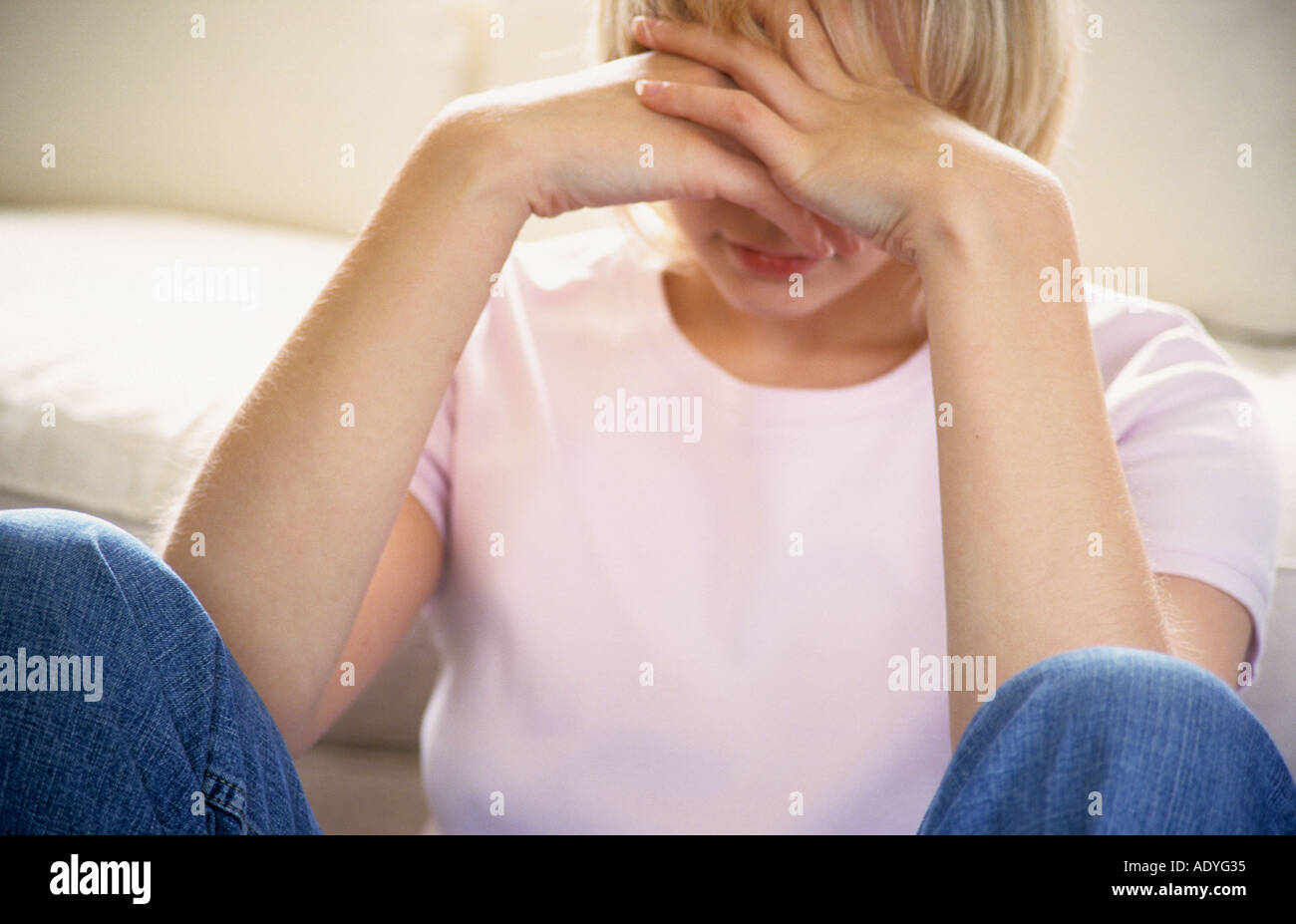 Young woman with head in hands Stock Photo - Alamy