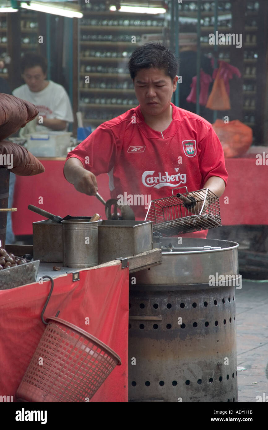 Man roasting chestnuts hi-res stock photography and images - Alamy