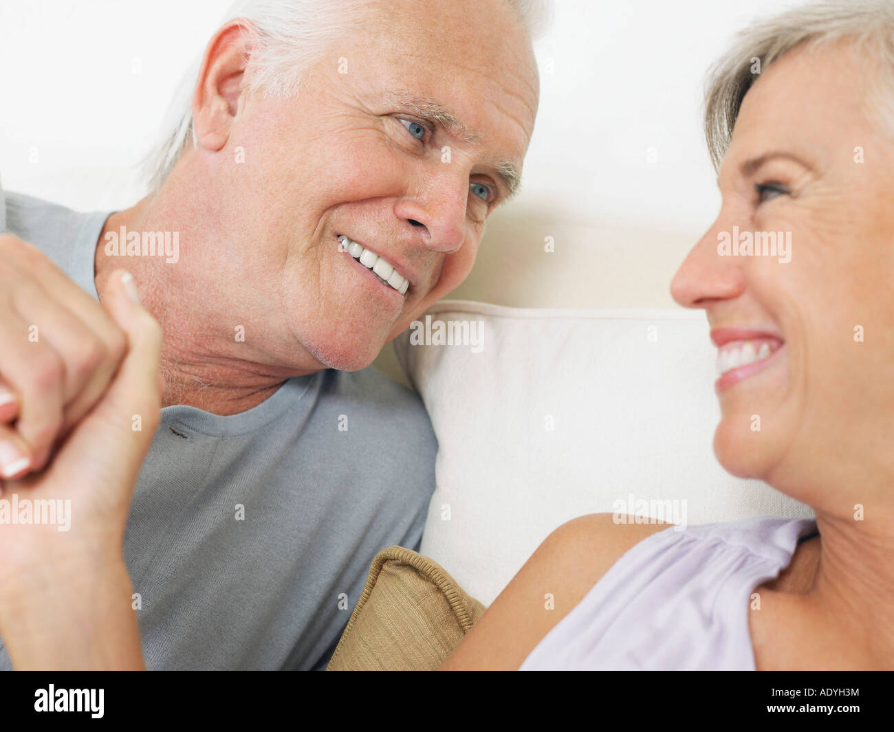 Couple holding hands and looking in eyes, close-up Stock Photo - Alamy