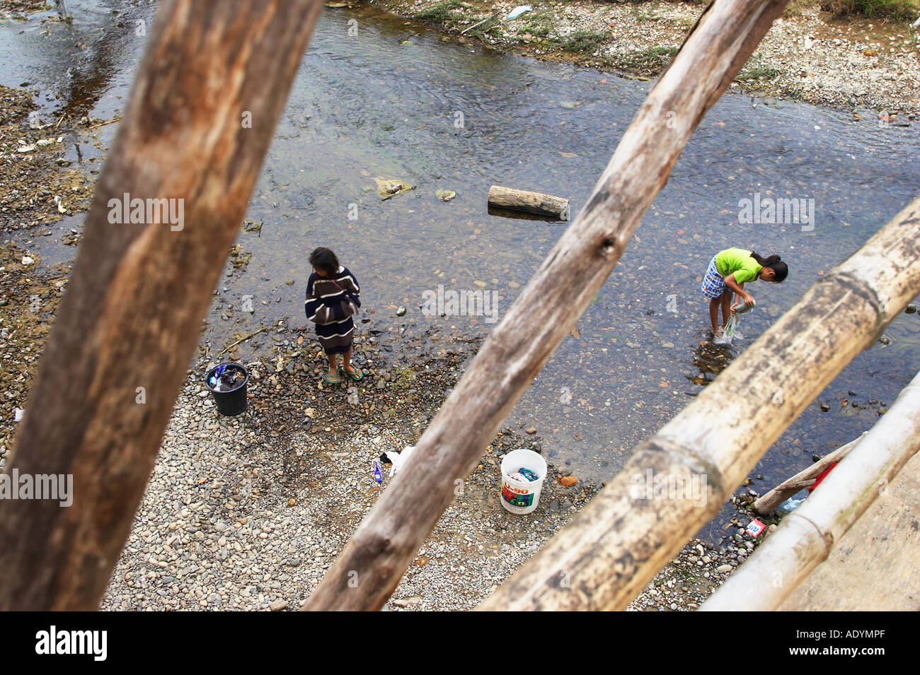 Girls washing clothes by the river hi-res stock photography and images ...