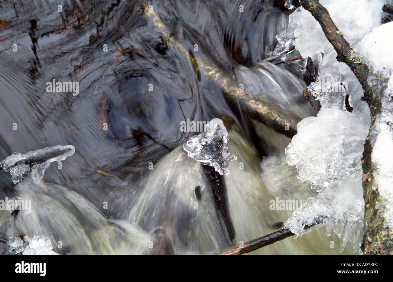 Water rushing over rocks and ice formations in Naruza river Ergli ...