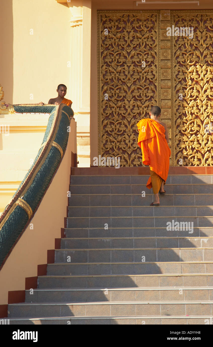 Monk Climbing Stairs At Wat That Luang Neua Stock Photo - Alamy