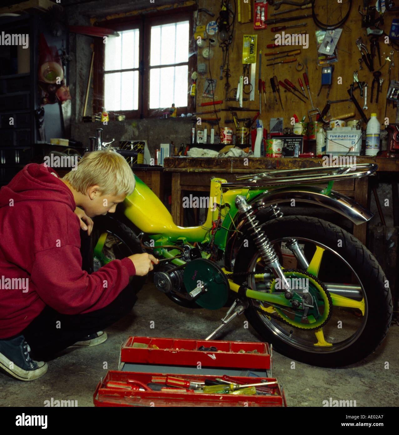 Teenager is tuning his moped Stock Photo - Alamy