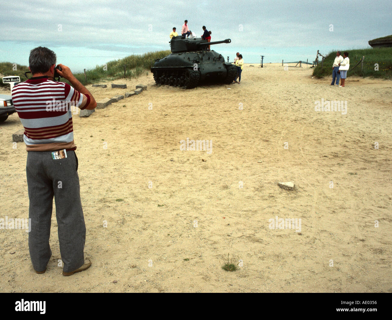 D Day tourist taking pictures of tanks and war relics Utah Beach France ...
