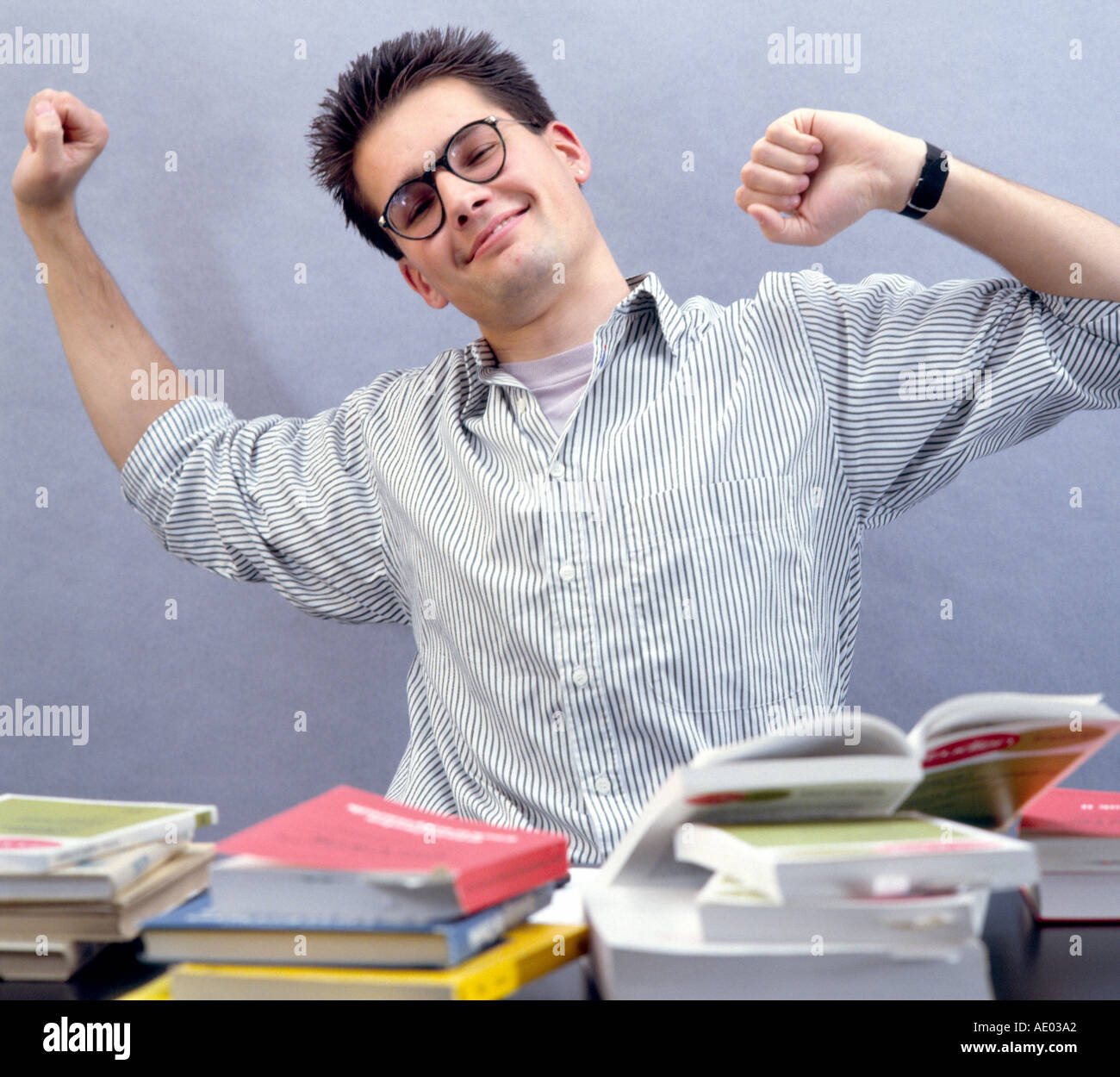 Student relaxing at his work Stock Photo - Alamy