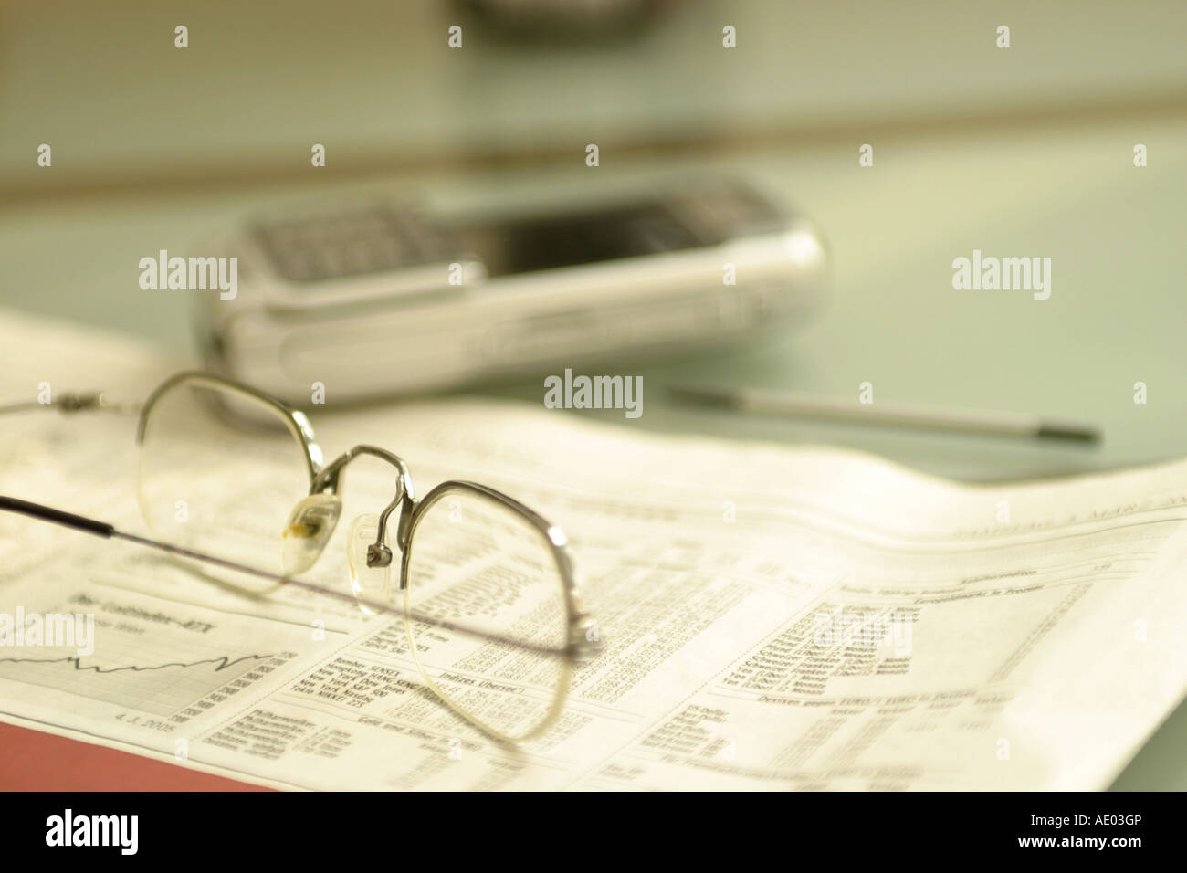newspaper with glasses and mobile phone Stock Photo - Alamy