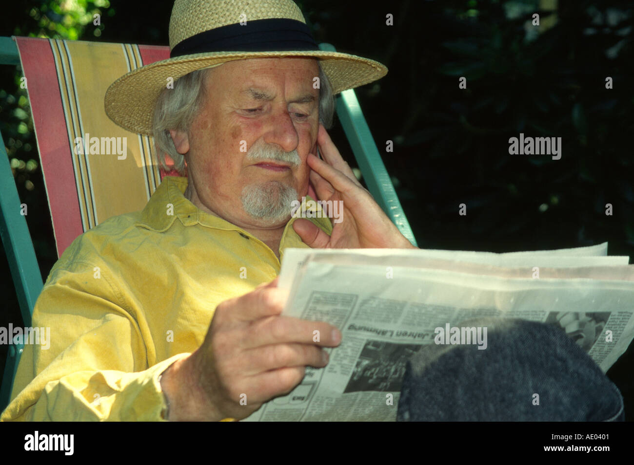 Old man reading newspaper in his garden Stock Photo - Alamy