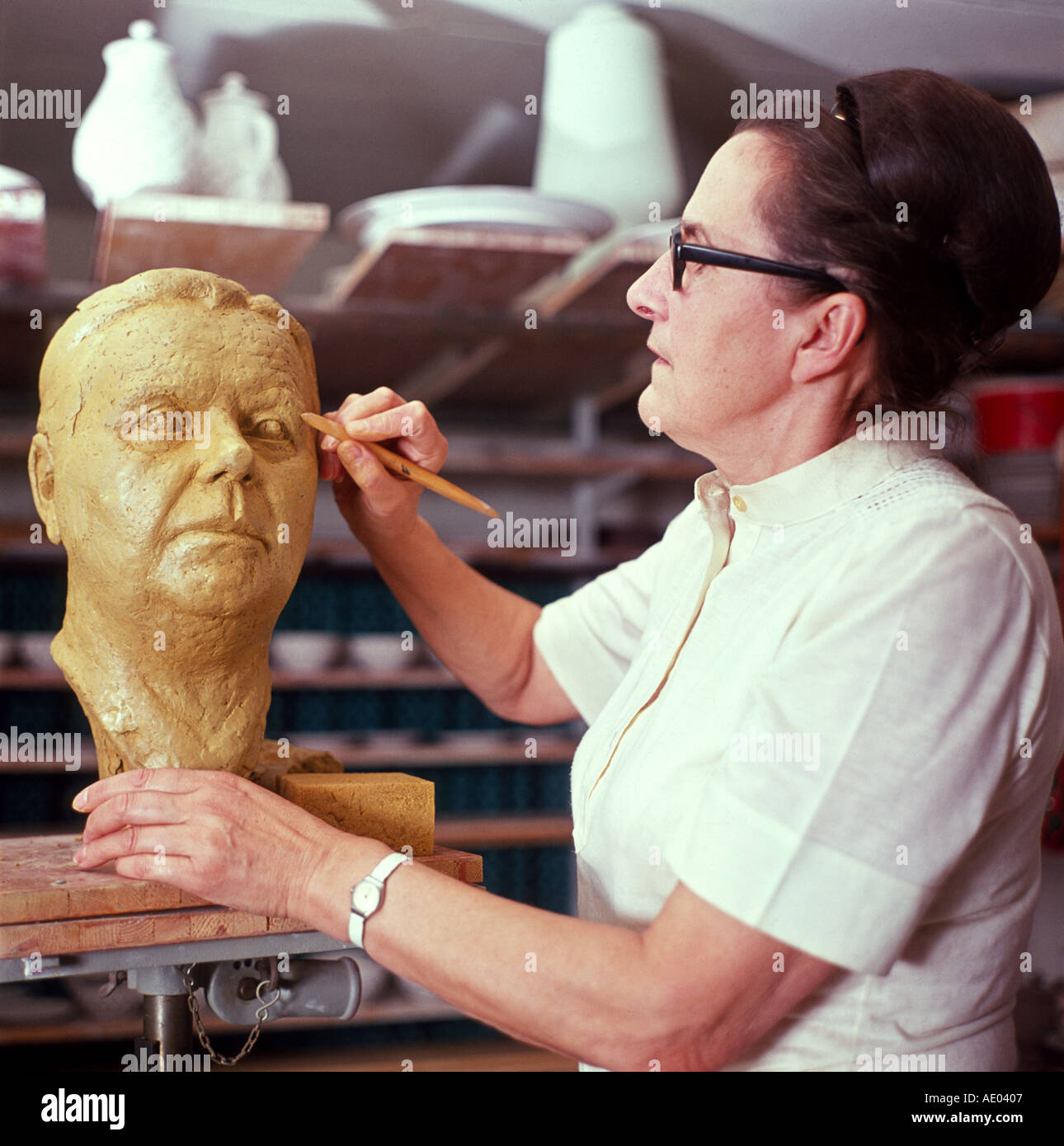 Old woman modelling a head with clay Stock Photo - Alamy