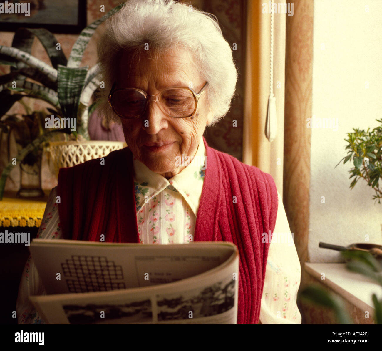 Old woman reading newspaper Stock Photo - Alamy