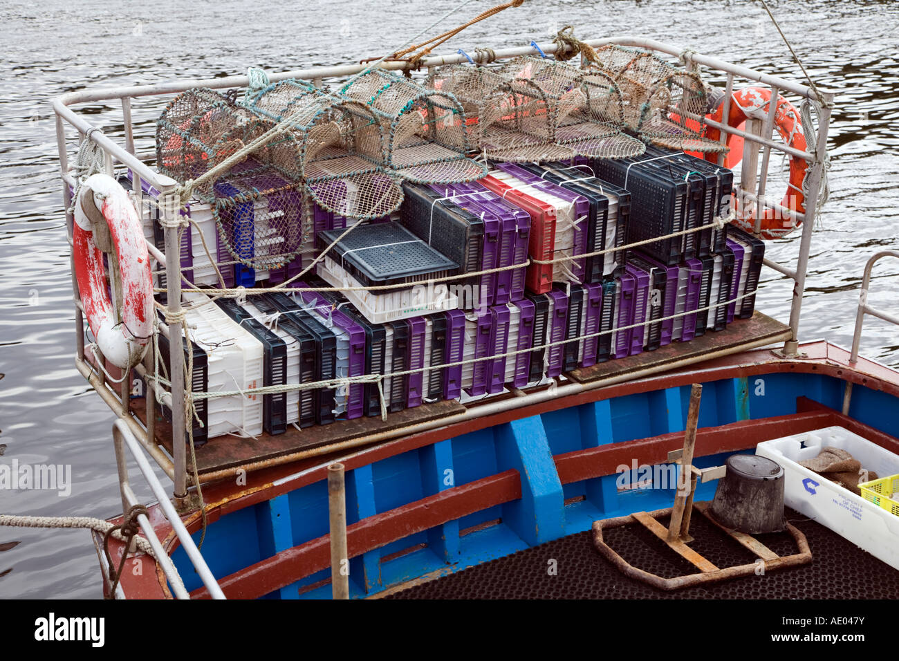 Fish boxes on back of fishing boat Stock Photo - Alamy