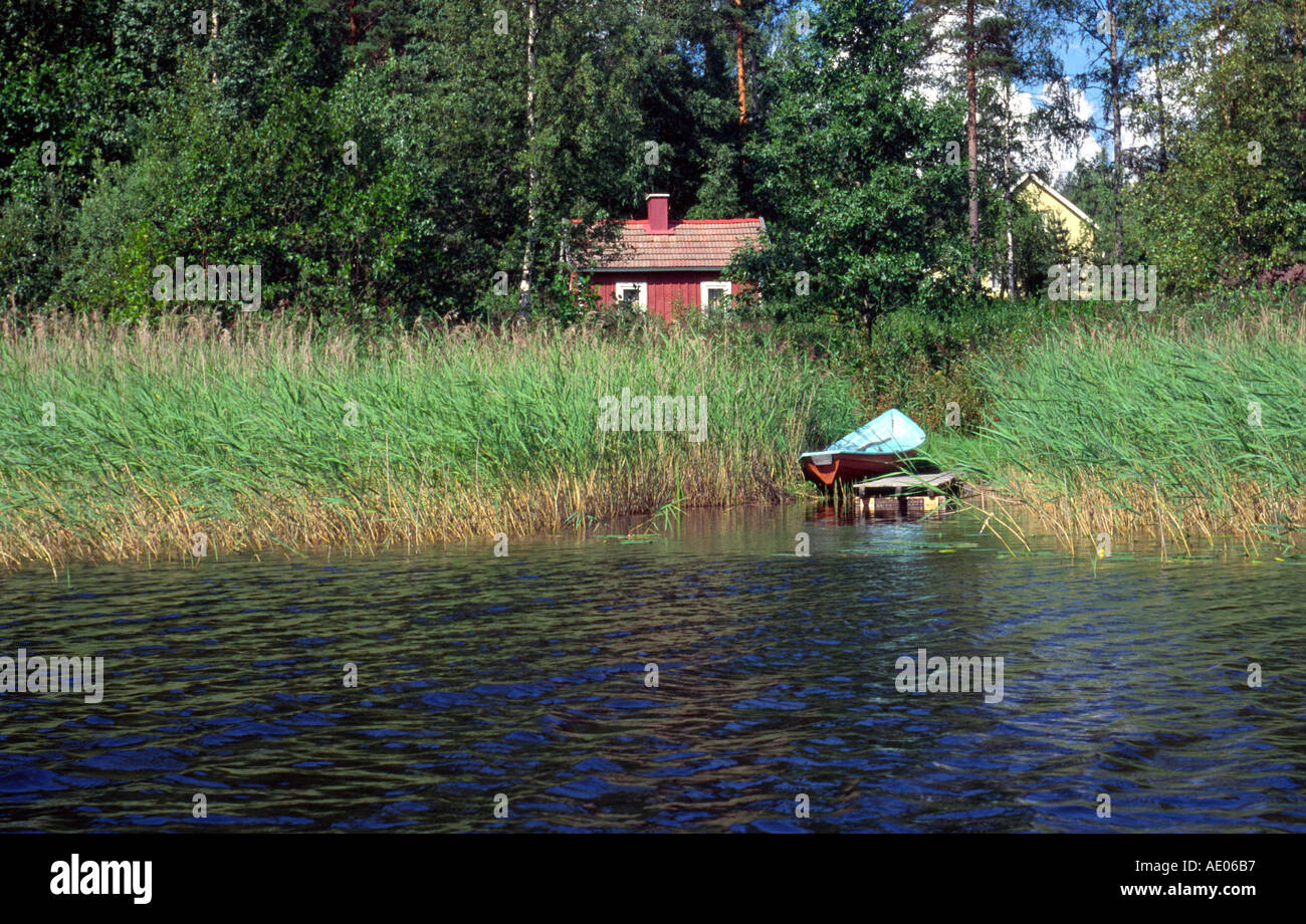 wooden house with a sauna and a boat at a lake Finland Stock Photo - Alamy