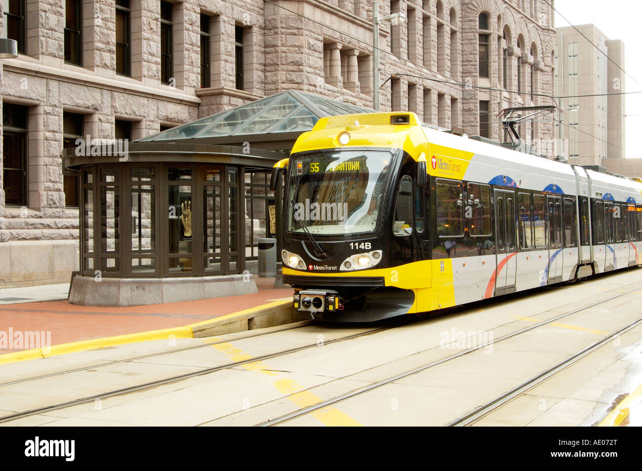 a light rail mass transit train in front of the government plaza in ...