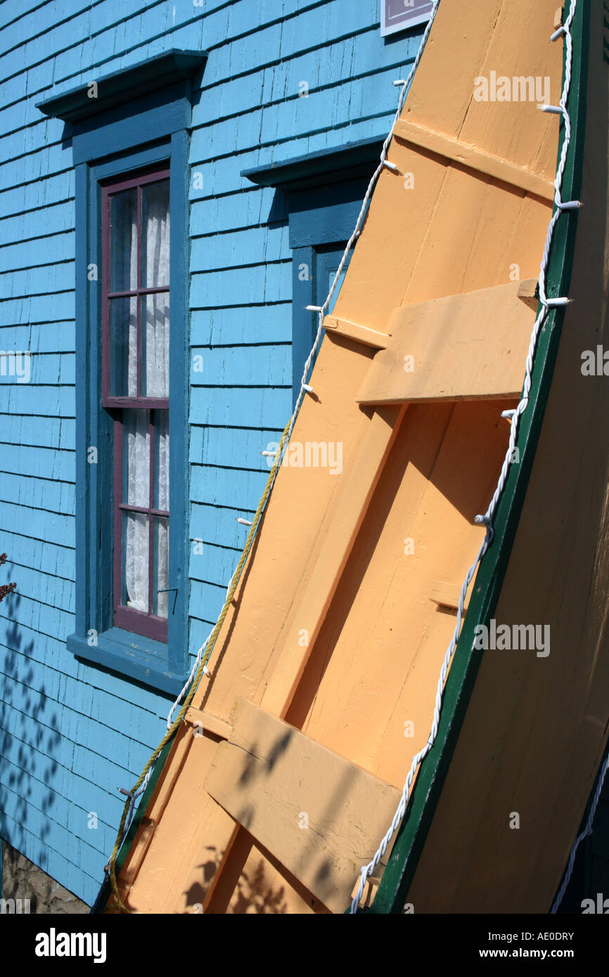 boat leaning on the facade of a house in Mahone Bay, Nova Scotia ...