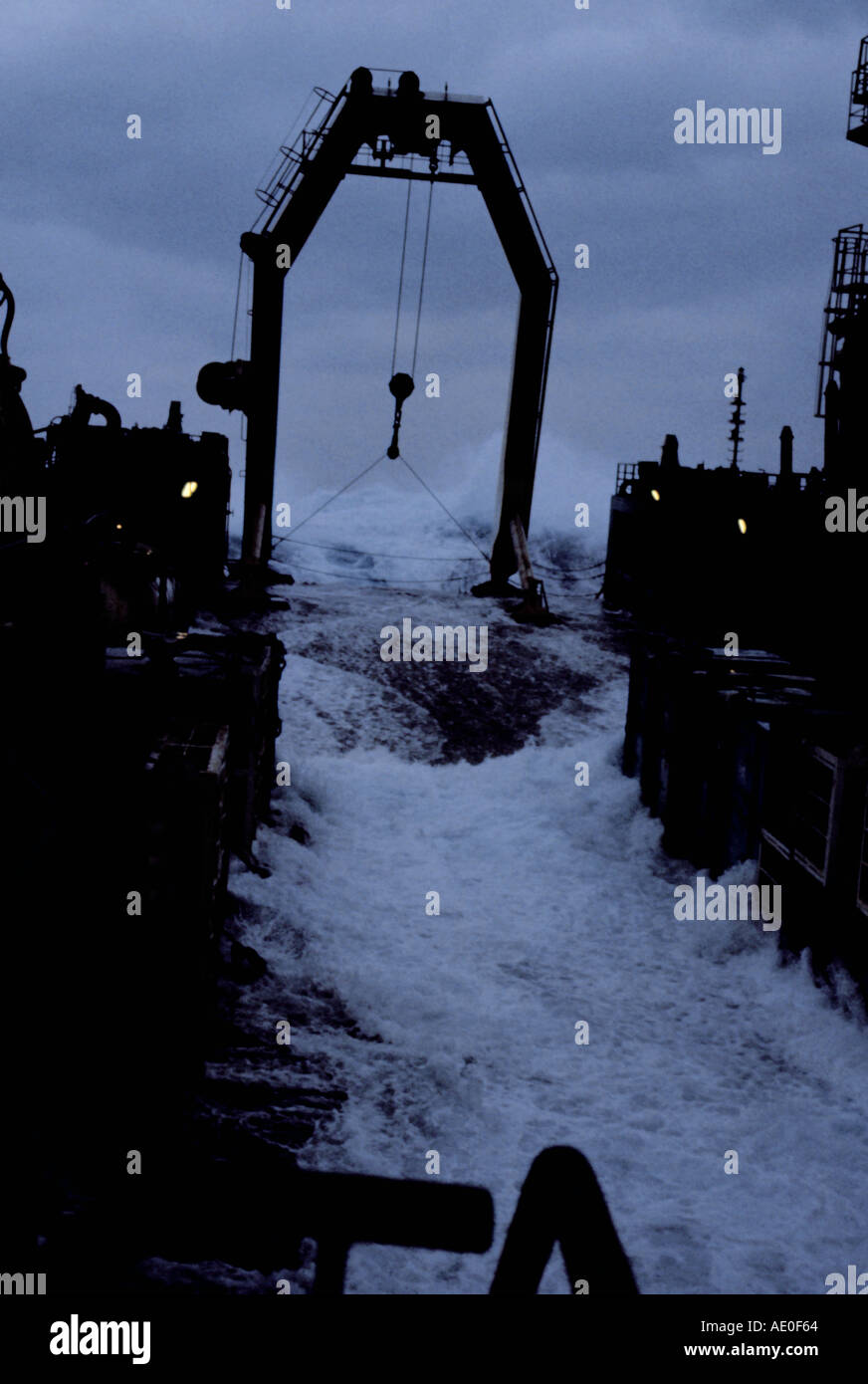 Stern deck of a DSV (diving support vessel) awash with sea water in bad ...