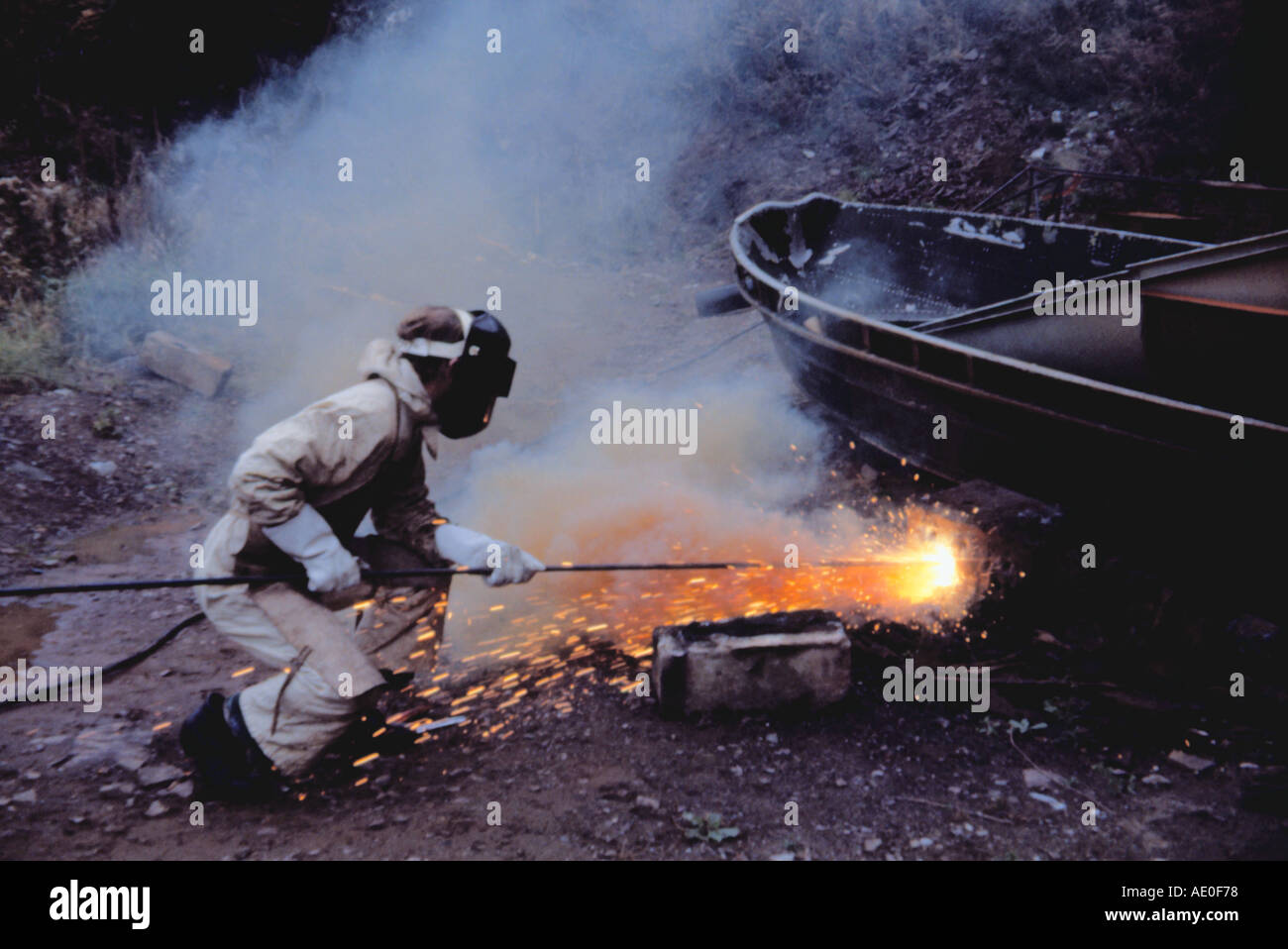 Man wearing protective clothing, using a thermic lance Stock Photo - Alamy