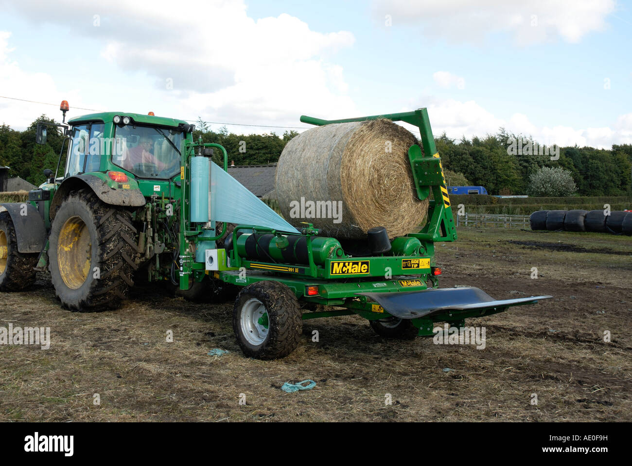 Wrapping round bales of hay for Haylage Stock Photo - Alamy