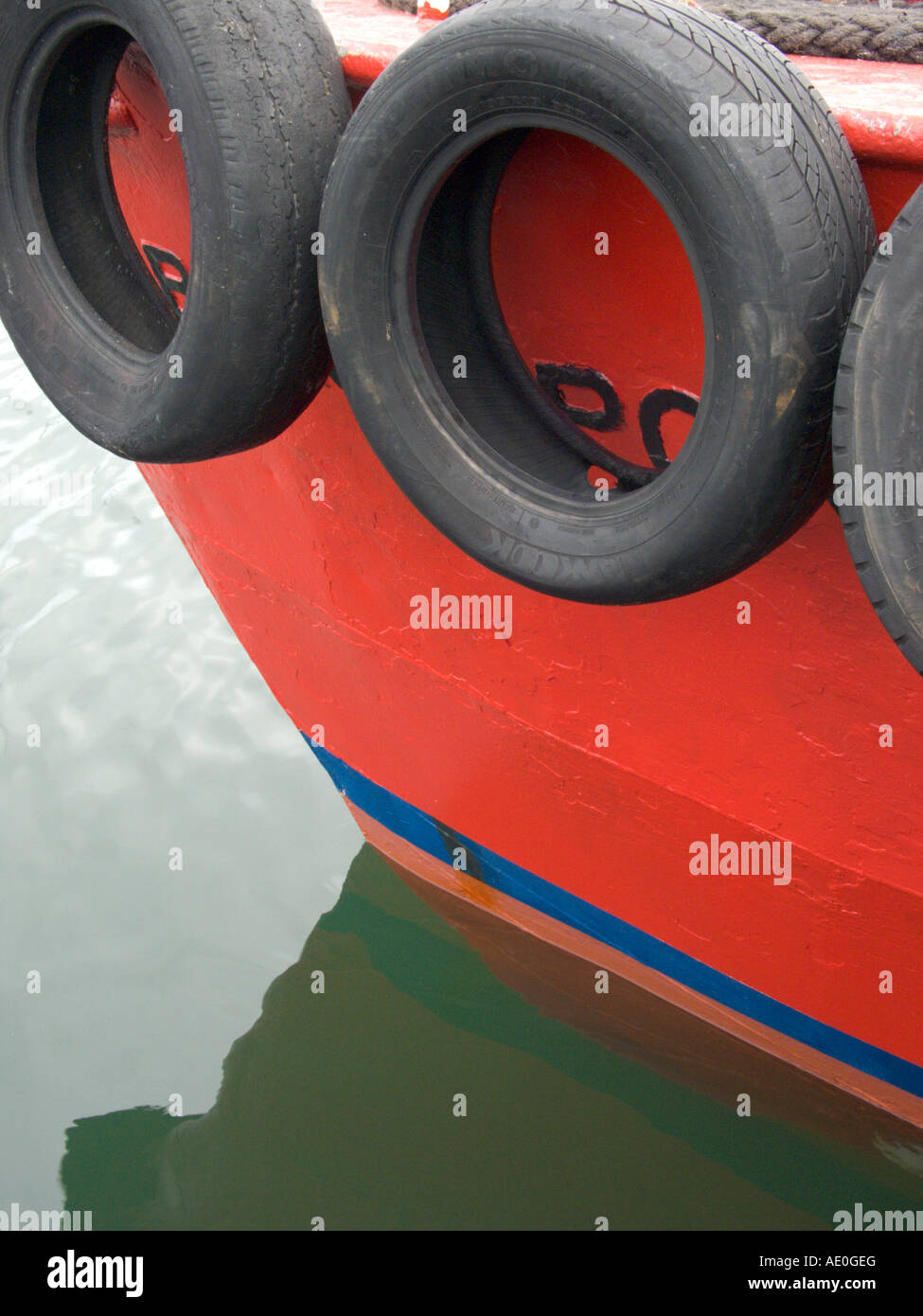 old tyres being used as bumpers on the side of a small boat Stock Photo ...
