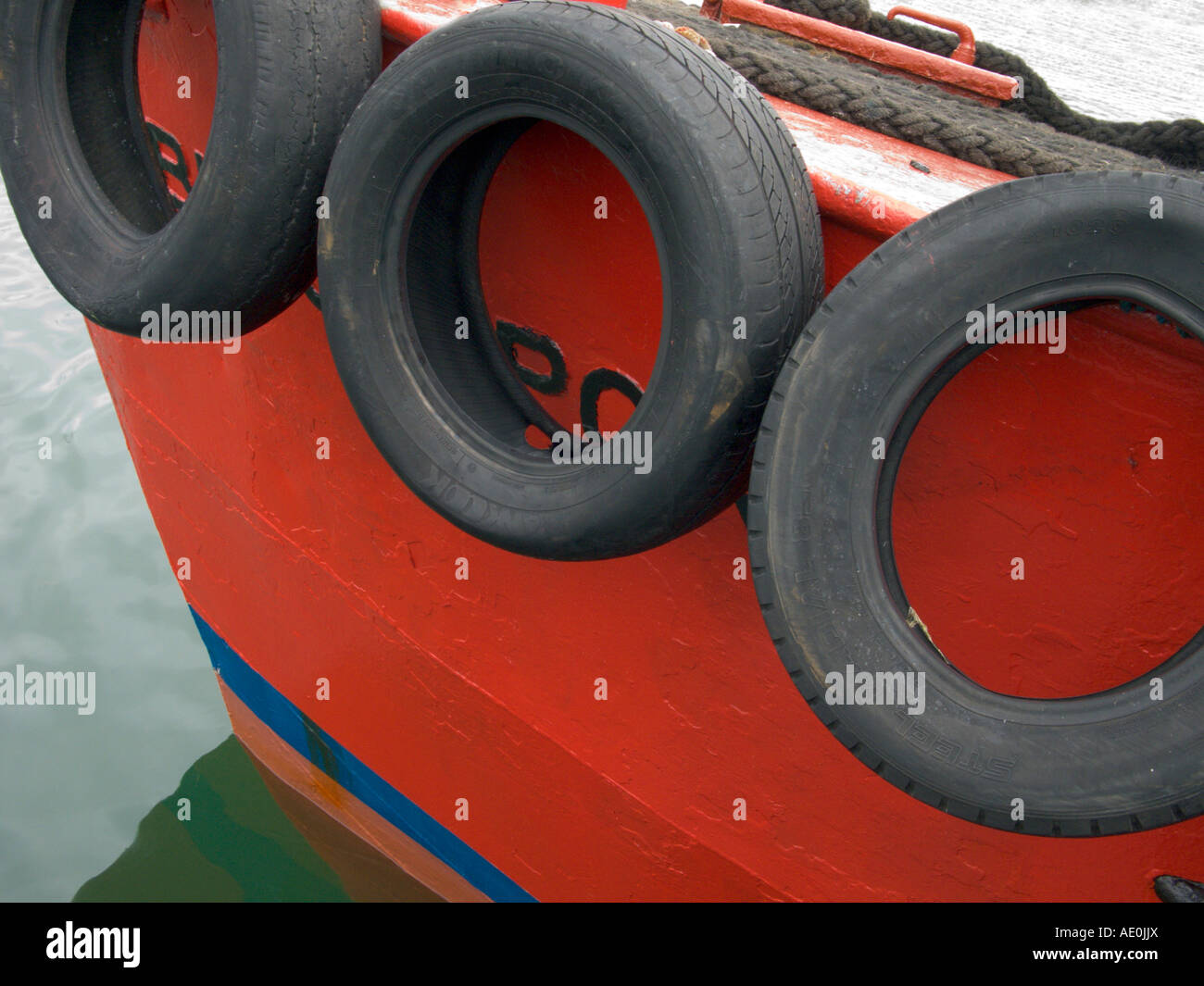 old tyres being used as bumpers on the side of a small boat Stock Photo ...