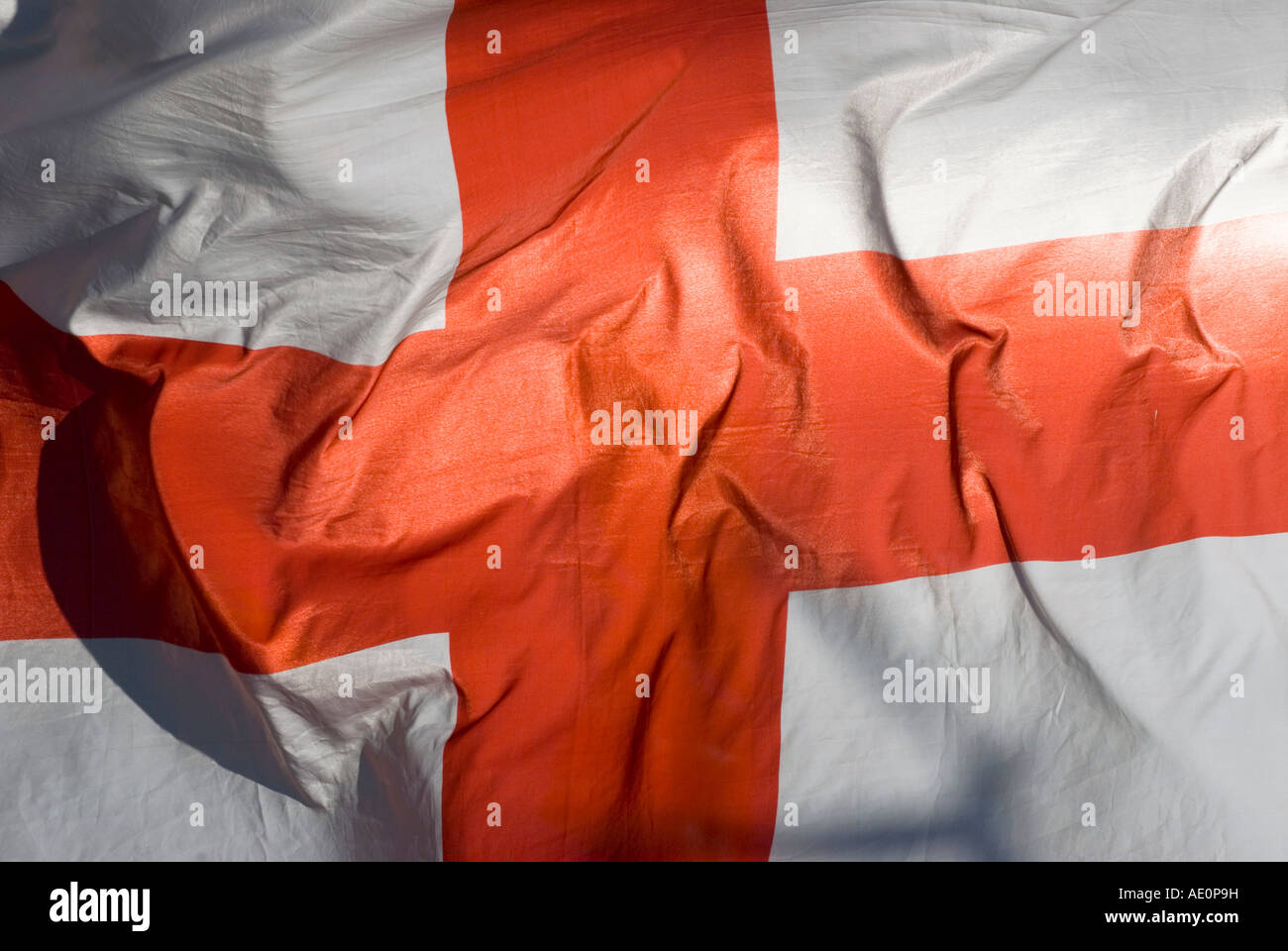 St Georges flag flying in the wind with the sun behind it Stock Photo ...