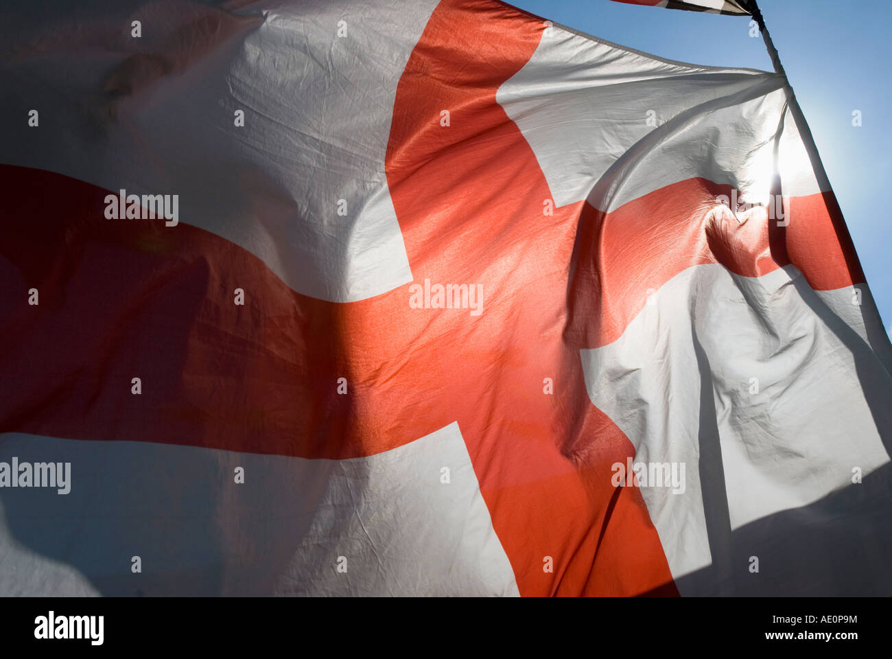St Georges flag flying in the wind with the sun behind it Stock Photo ...