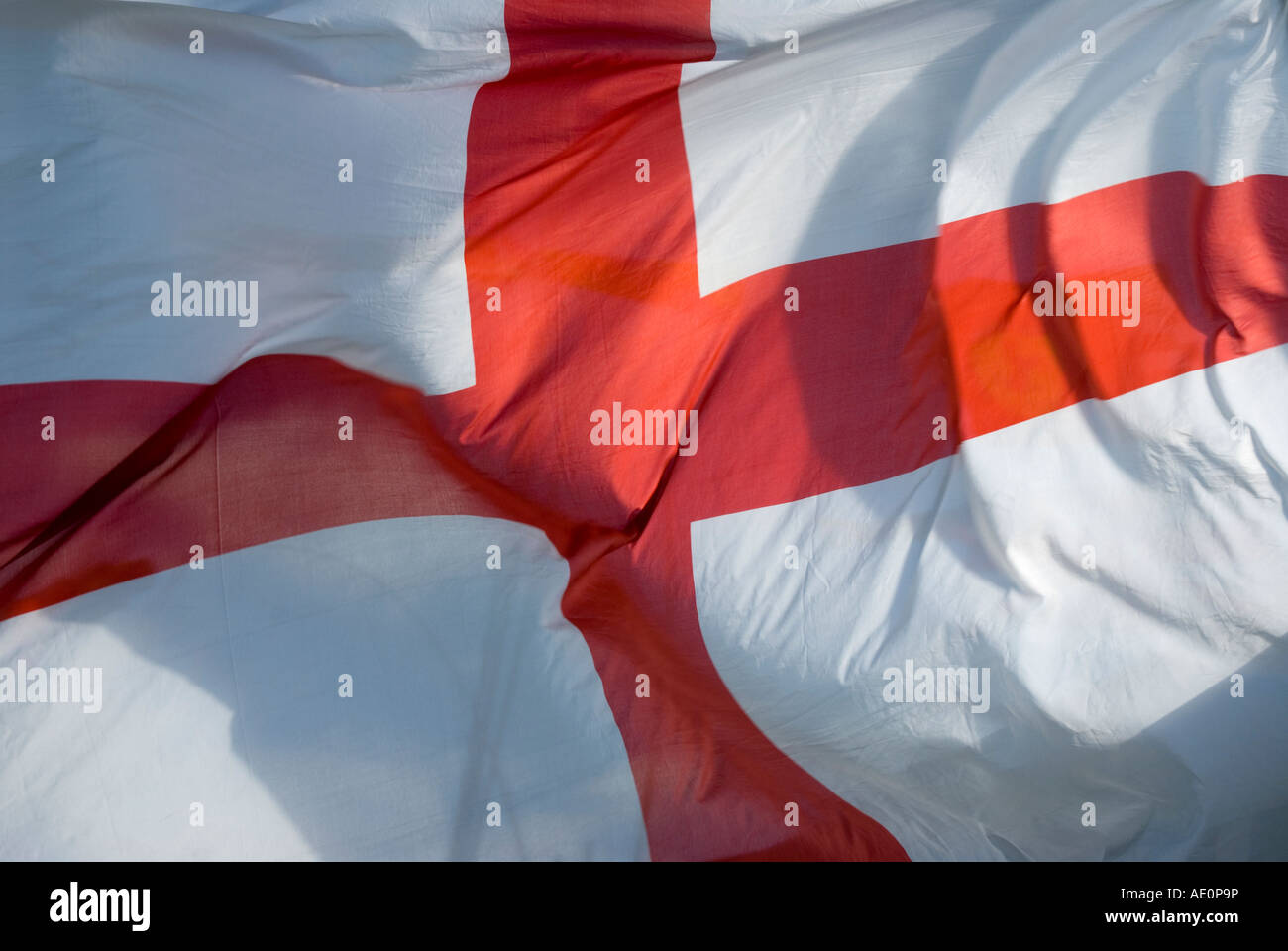 St Georges flag flying in the wind with the sun behind it Stock Photo ...