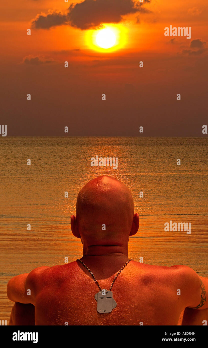 Contemplating sunset over sea Stock Photo - Alamy