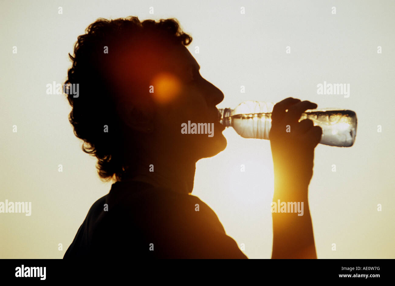 Woman drinking bottled water, Bawdsey, Suffolk, UK Stock Photo - Alamy