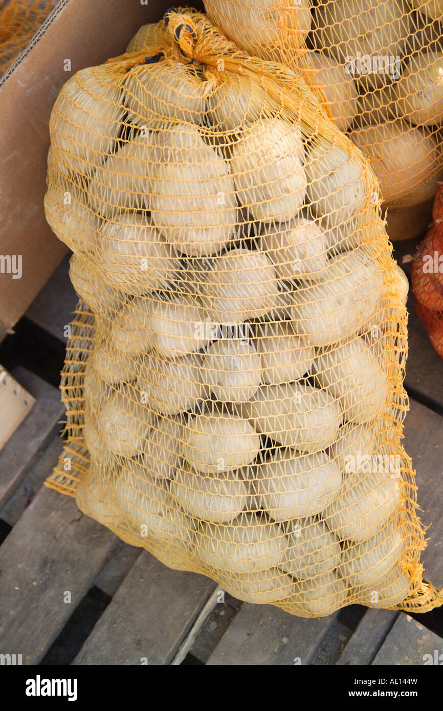 Potatoes in net bag Stock Photo - Alamy