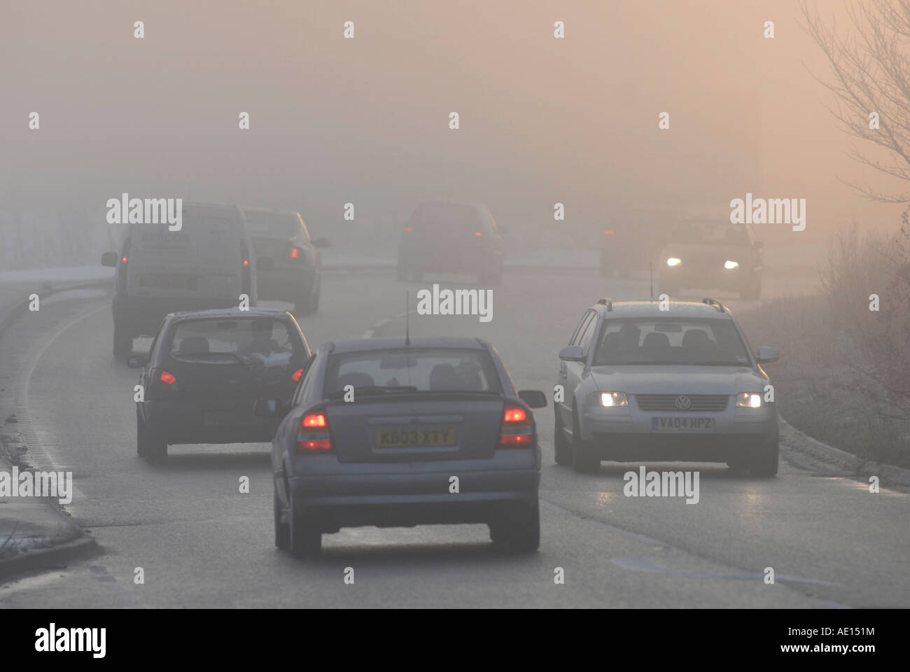 Cars being driven in foggy conditions on a road in the uk Stock Photo ...