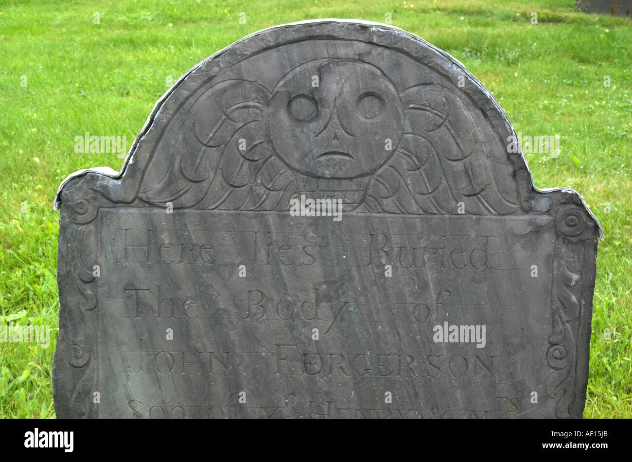 A very old gravestone showing the Deaths Head in the Old Burying Ground ...