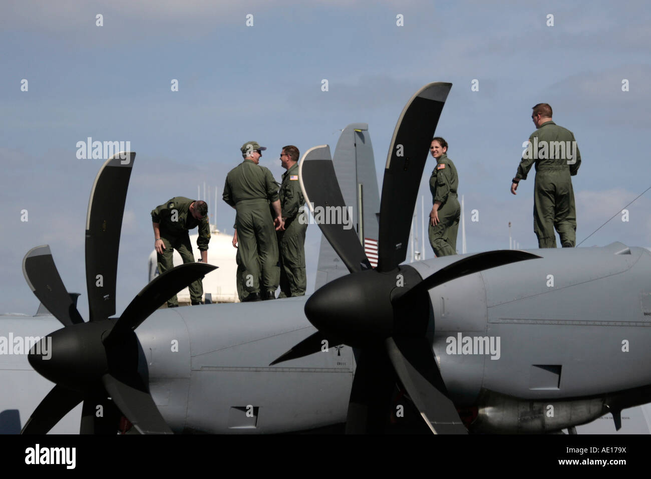 Military Men & Women on Wing and Engines of Large Prop Driven War Plane ...