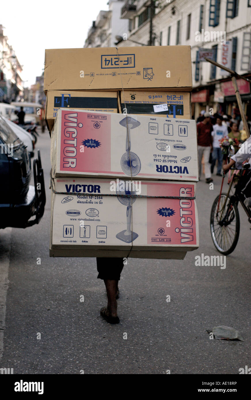 Man carrying large boxes on his back Stock Photo - Alamy