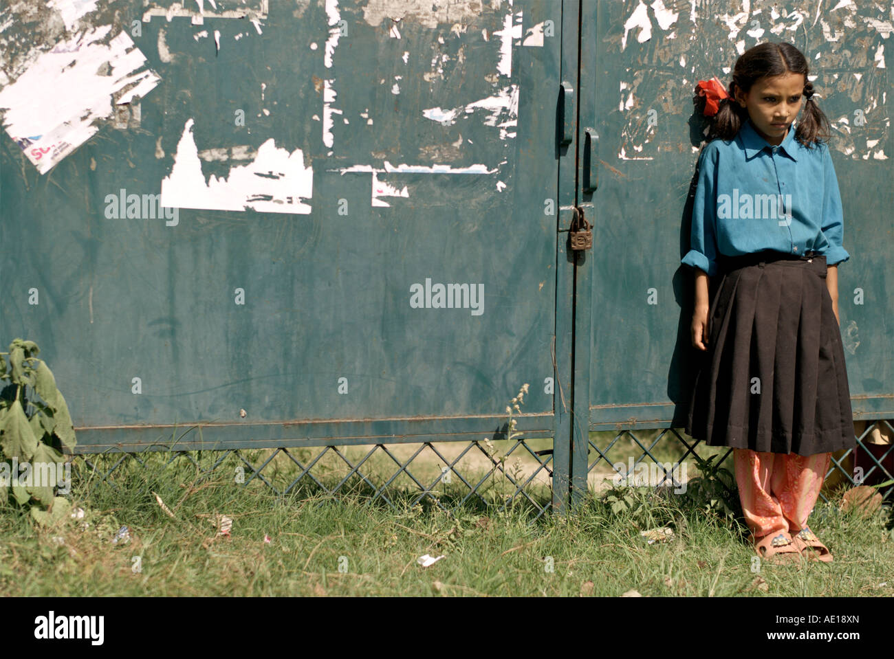 Mysterious girl standing by a gate Stock Photo - Alamy