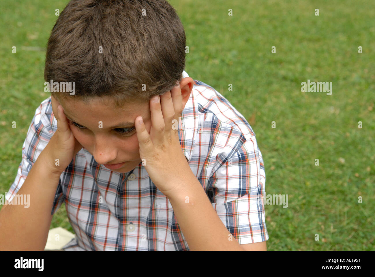 Boy deep in thoughts Stock Photo - Alamy