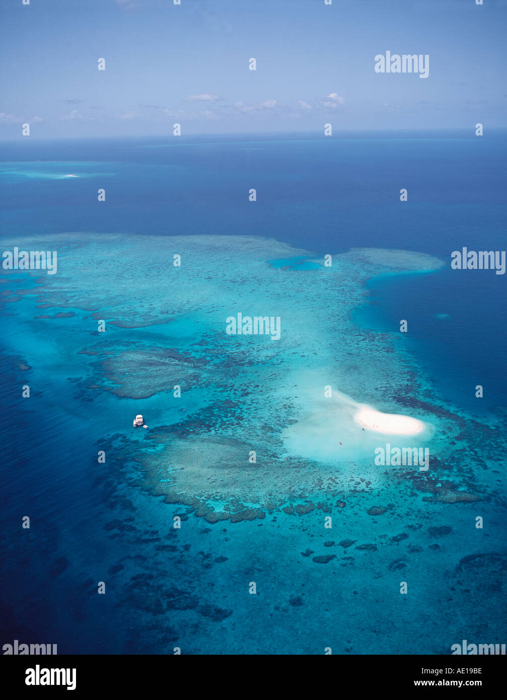 Aerial of tourist vessel visiting a coral sand cay on the Great Barrier ...