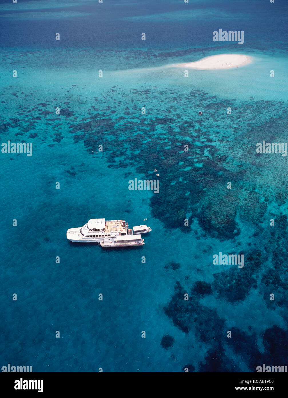 Aerial of tourist vessel visiting a coral sand cay on the Great Barrier ...