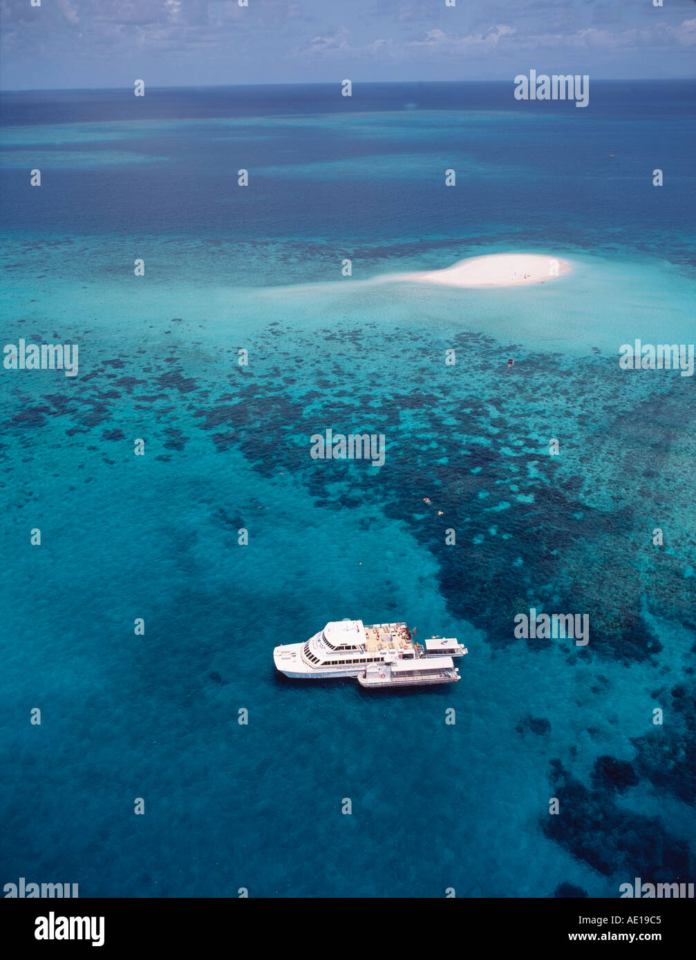 Aerial of tourist vessel visiting a coral sand cay on the Great Barrier ...