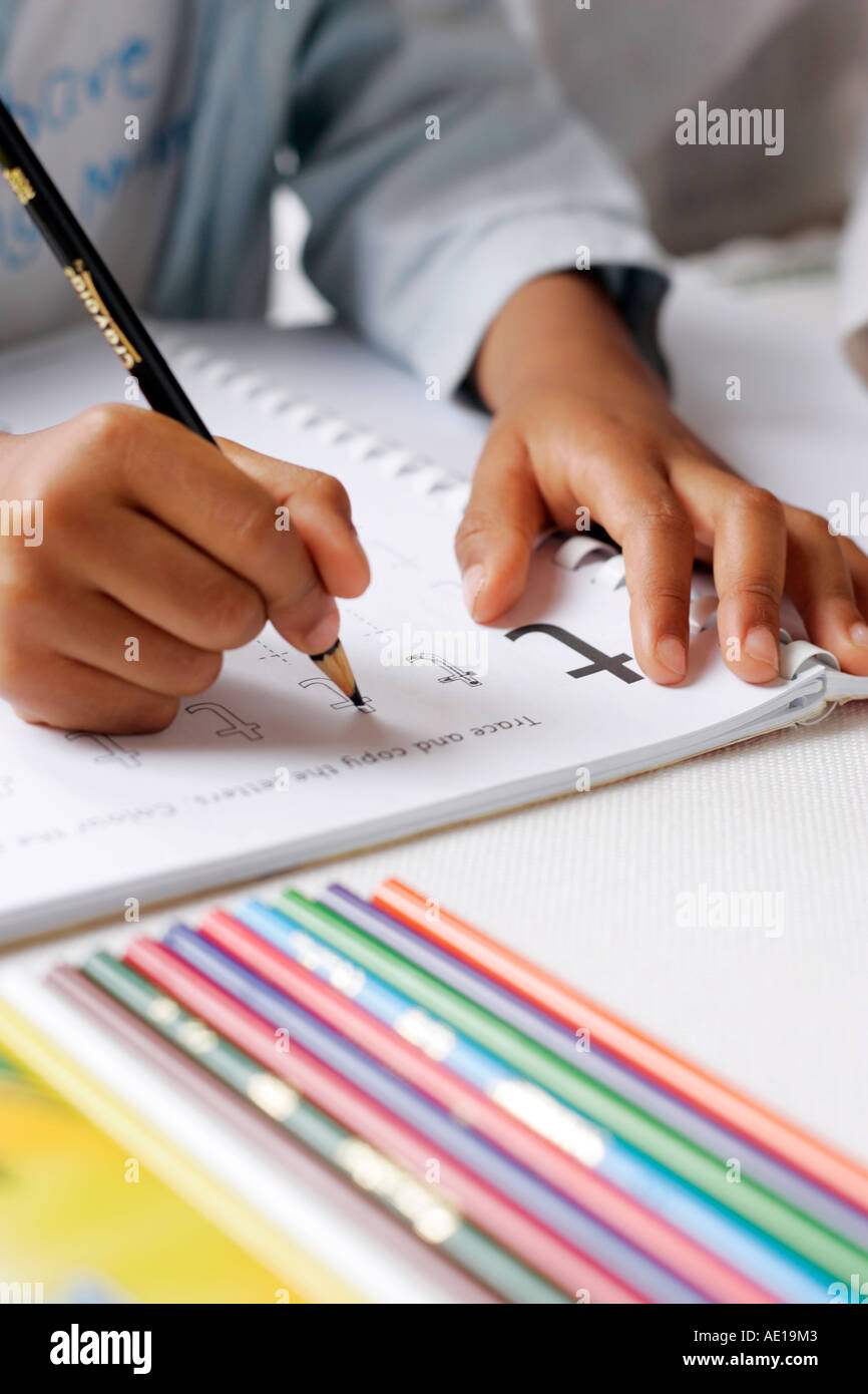 Ethnic child writing/drawing Stock Photo - Alamy