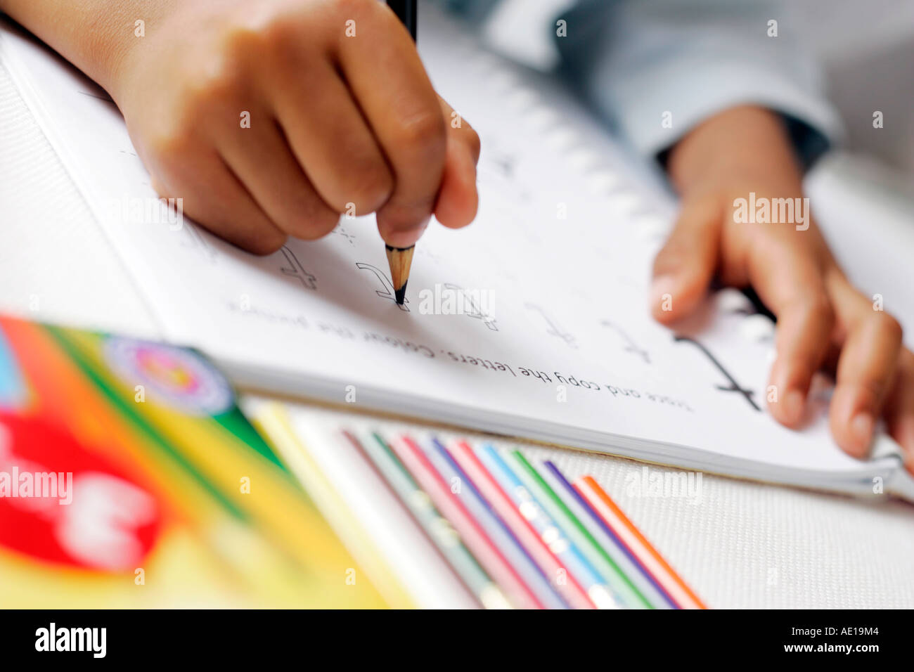 Ethnic child writing/drawing Stock Photo - Alamy